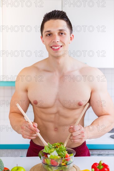Prepare salad eat man bodybuilder lunch kitchen healthy food vertical ...