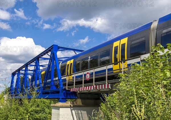 Regional train crossing a blue railway bridge - Photo12-imageBROKER ...