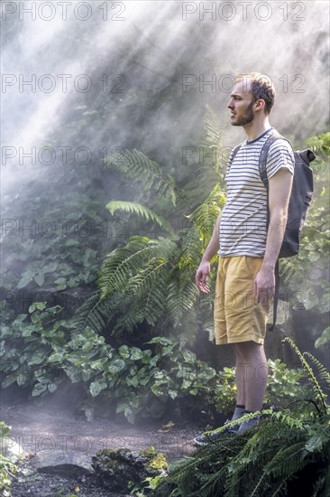 Young man standing in fog - Photo12-imageBROKER-Moritz Wolf