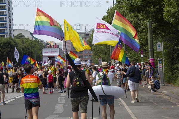 Flag-waving colorful participants marching to start of Christopher ...