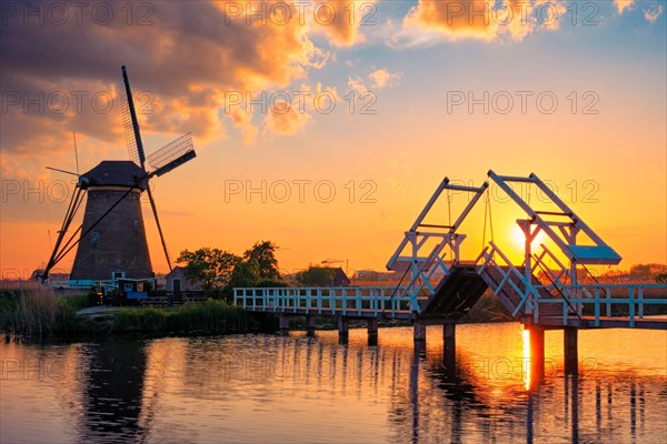 Netherlands rural landscape with windmills and bridge at famous tourist ...