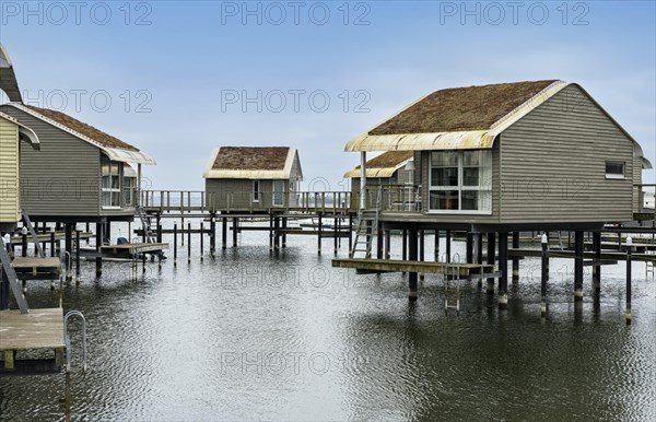 Pile dwellings as holiday homes with boat mooring - Photo12-imageBROKER ...