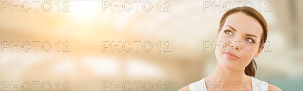 Contemplative young adult woman looking off to the side with room for ...