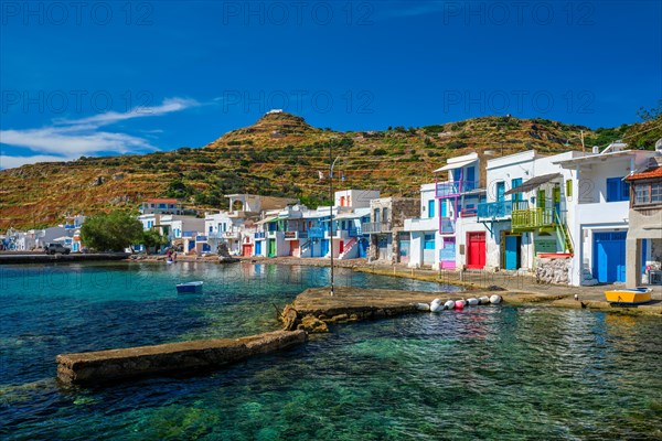 Picturesque Greek fishing village with white houses and colorful doors ...
