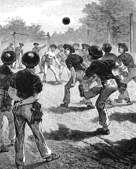 Young men playing football at a sports ground in London in 1870 ...