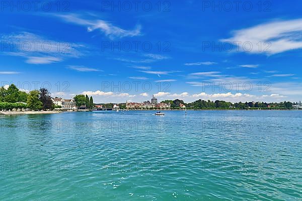 View of Lake Constance from harbor with old historic buildings in ...