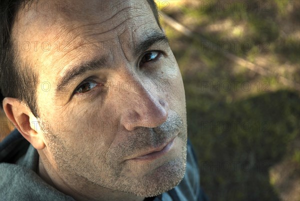 High angle view portrait of an adult man looking at the camera ...