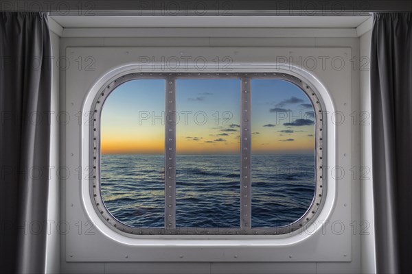 View through the cabin window of a cruise ship at evening mood ...