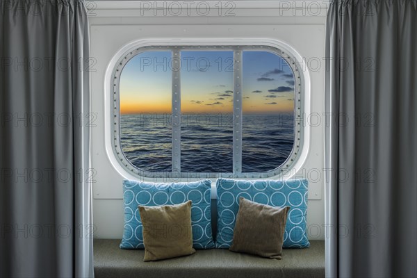 View through the cabin window of a cruise ship at evening mood ...