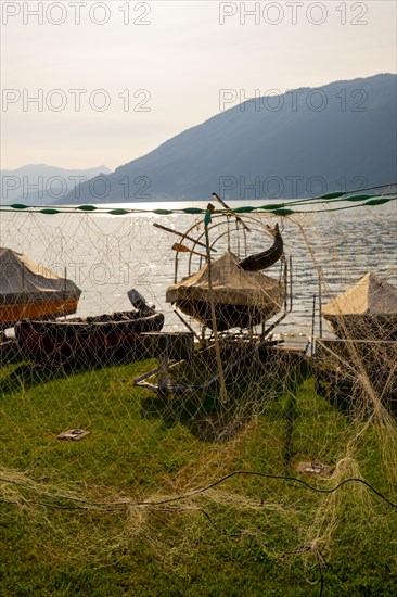 Fishing Net with a Fish and Fishing Boat on the Background and Lake ...