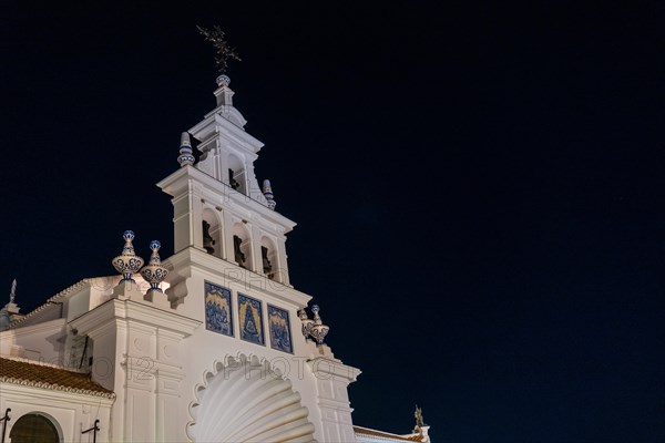 White facade of the sanctuary of Rocio in the fiesta del rocio at night ...
