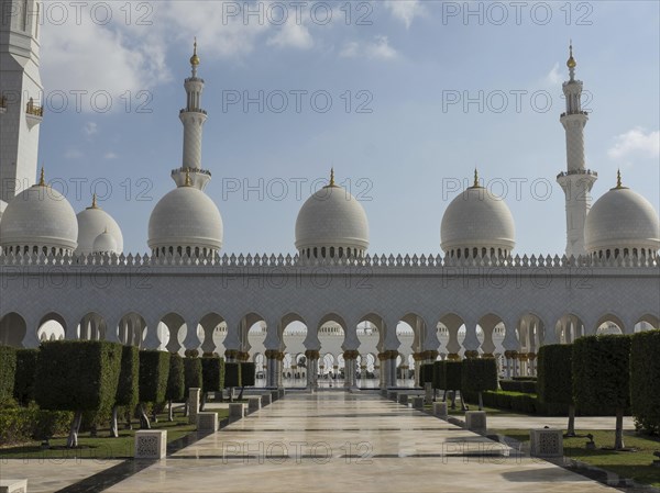 Magnificent mosque with multiple domes and minarets, emphasised by ...