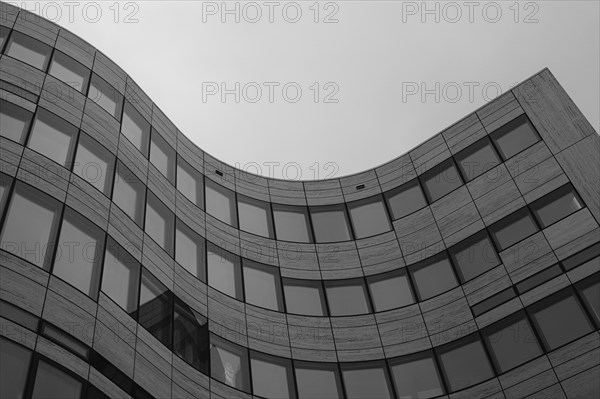 Wave-shaped building in the historic city centre, black and white ...